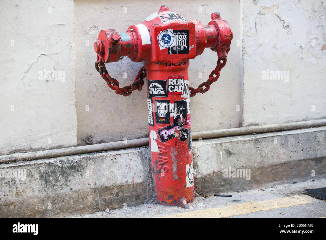 Outdoor red fire hydrant pasted with stickers Stock Photo - Alamy