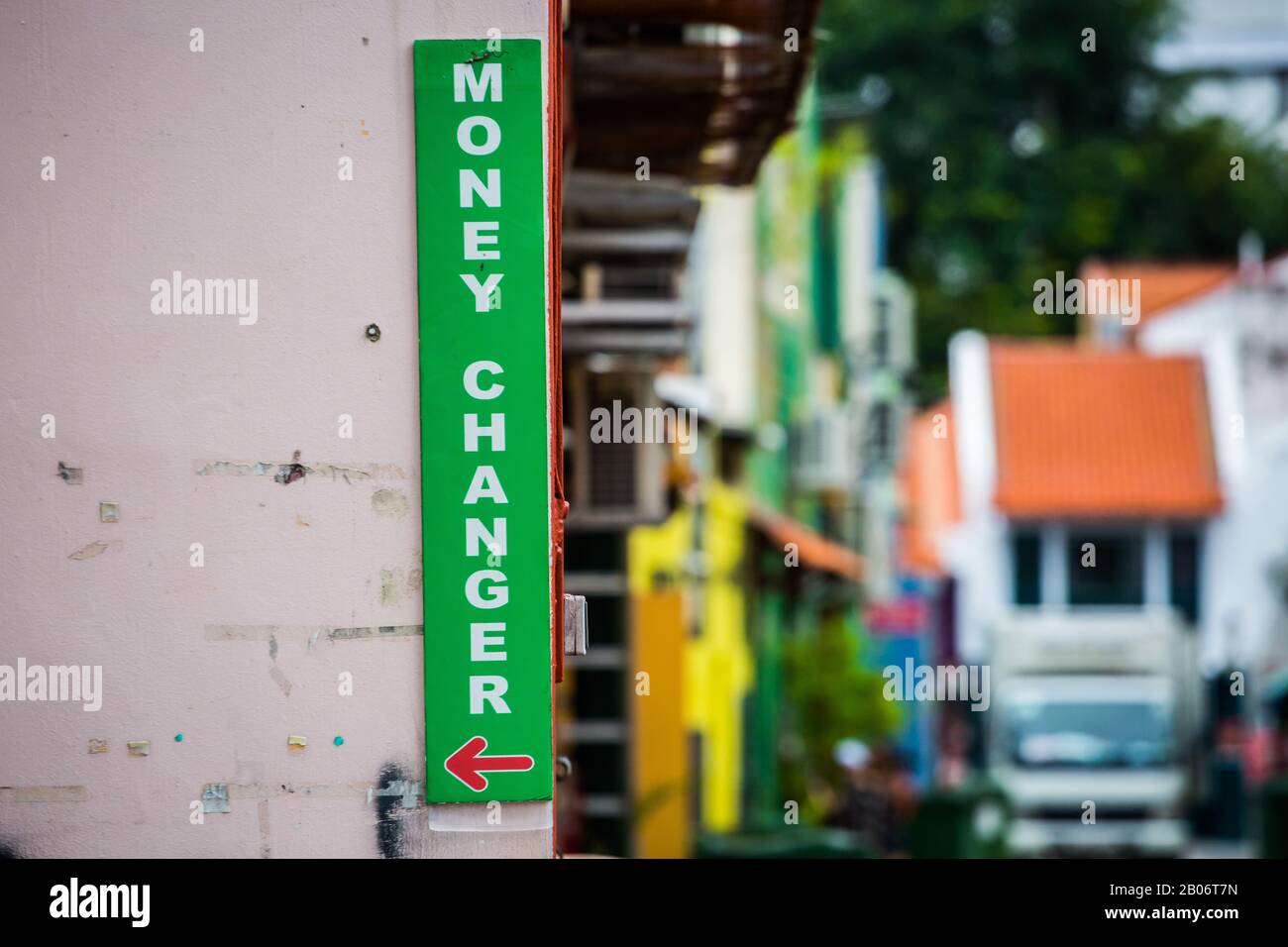 Money changer vertical green signboard with red arrow direction is ...