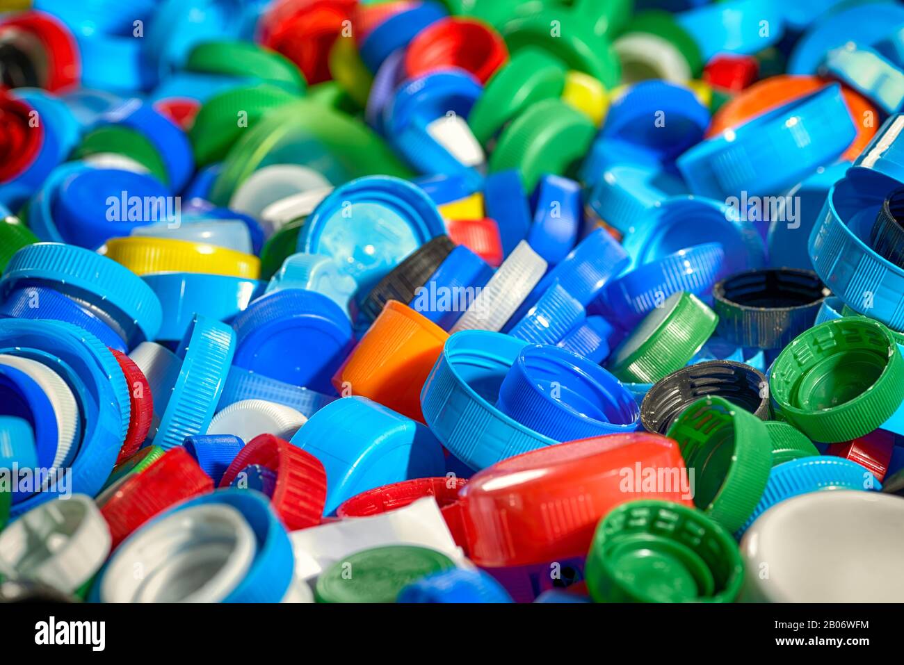 Colorful bottle plastic caps spread and ready to be recycled. Close-up ...