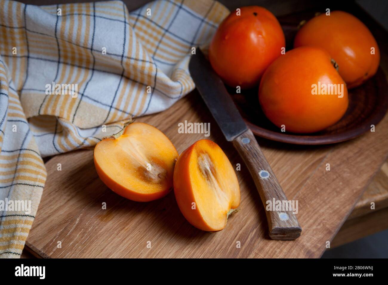 Composition of ripe delicious whole persimmon fruits, half and sliced ...