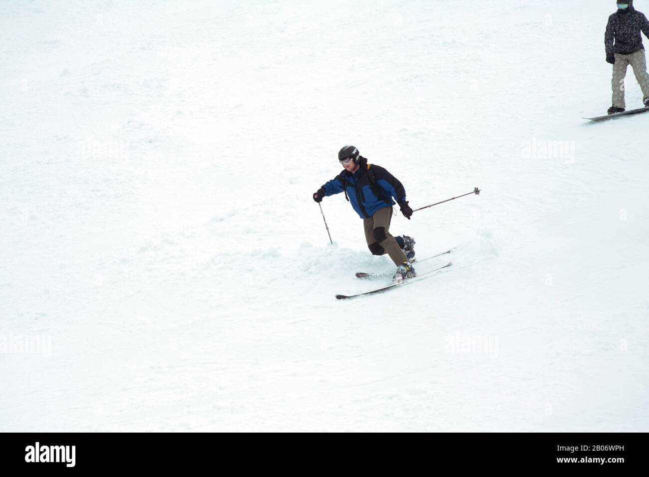 Ski resort. The skier quickly rides down a snow-covered professional ...
