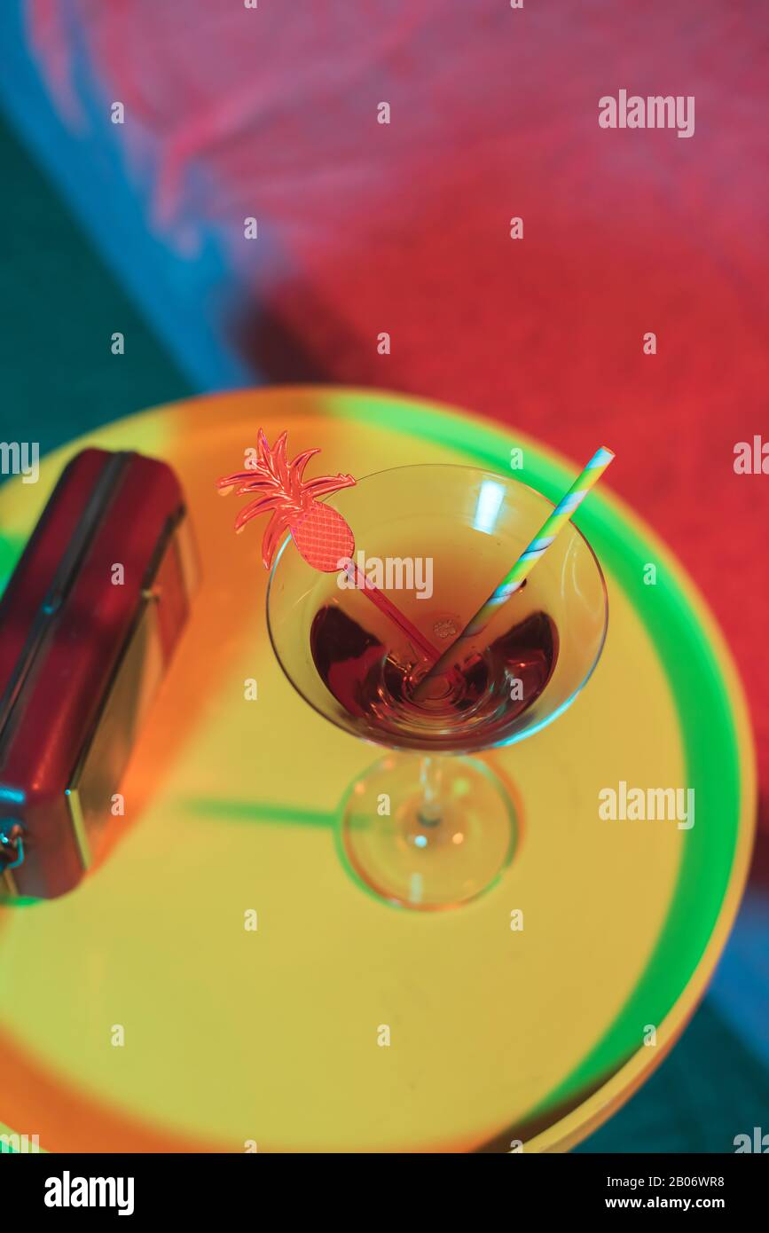 Yellow table with cocktail drink and portable radio next to sunbed ...