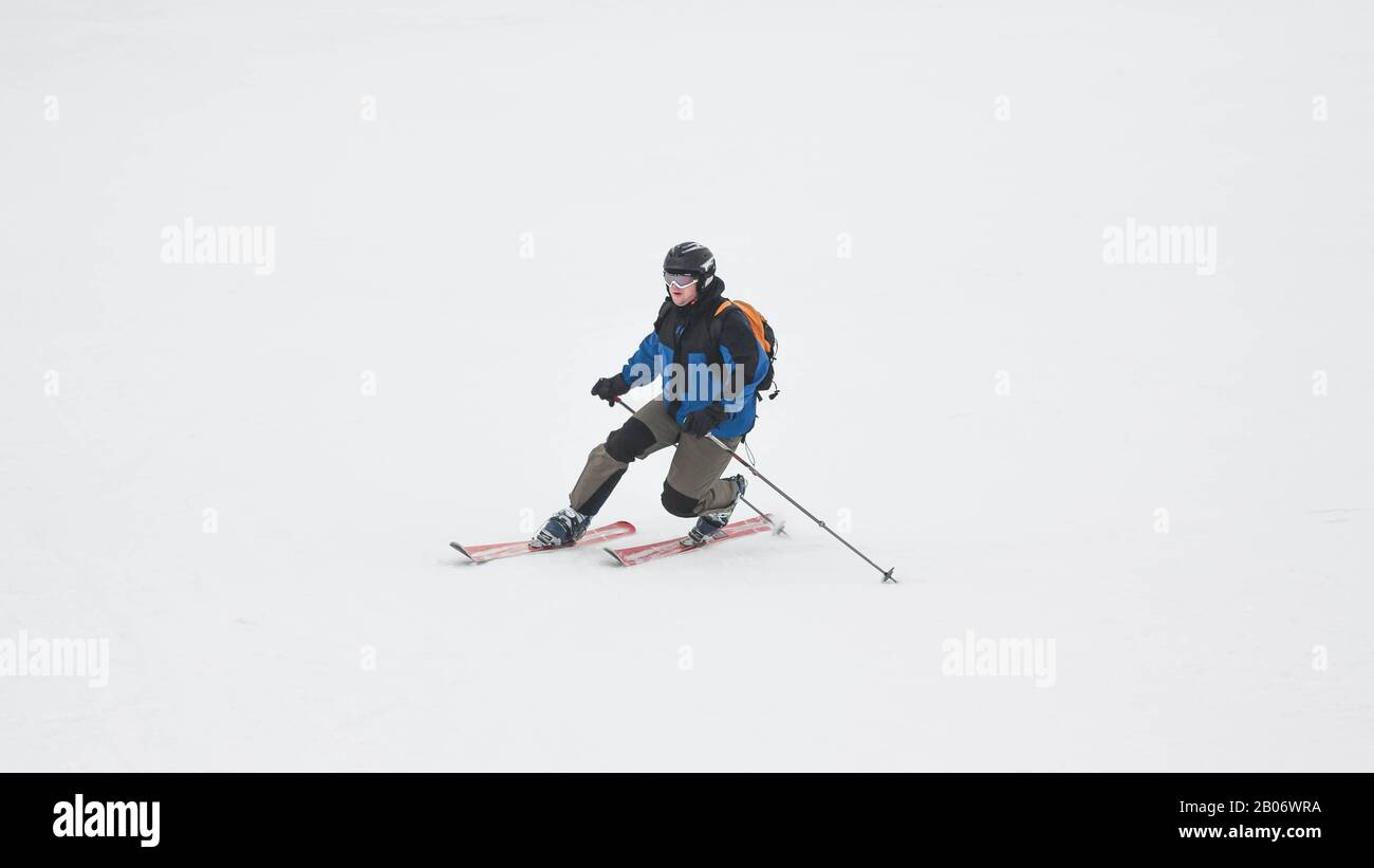 Ski resort. The skier quickly rides down a snow-covered professional ...