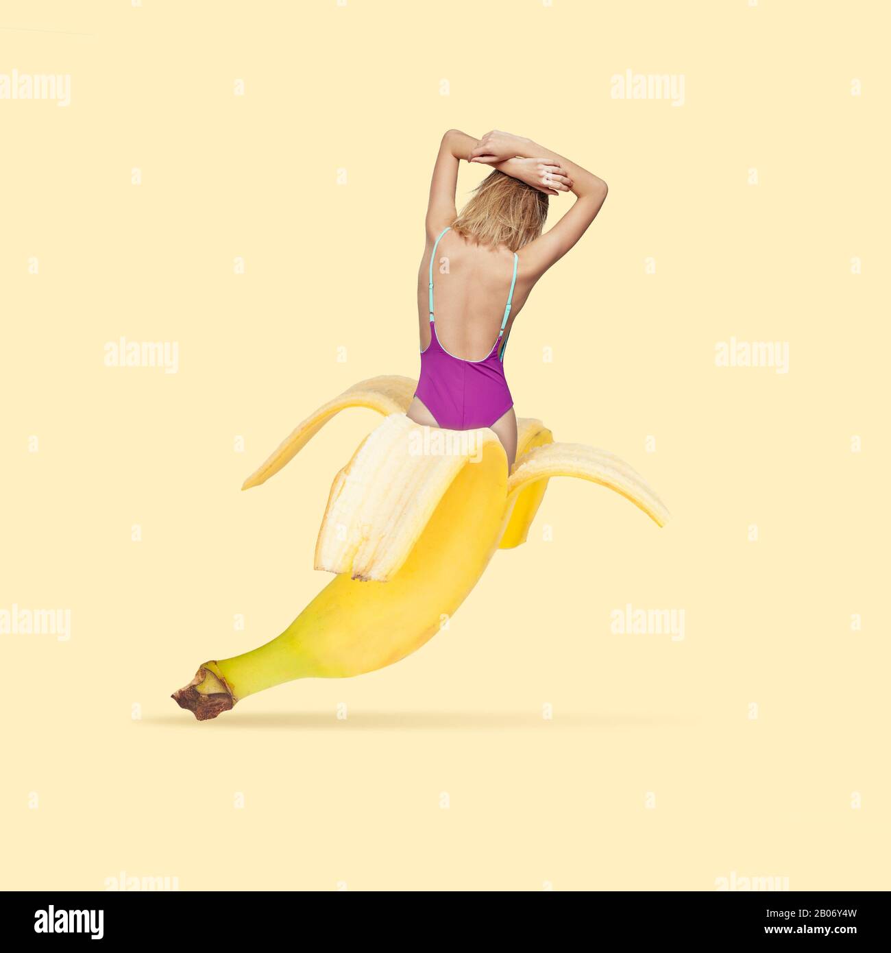 Sweet taste. Female body covered in banana on yellow background ...