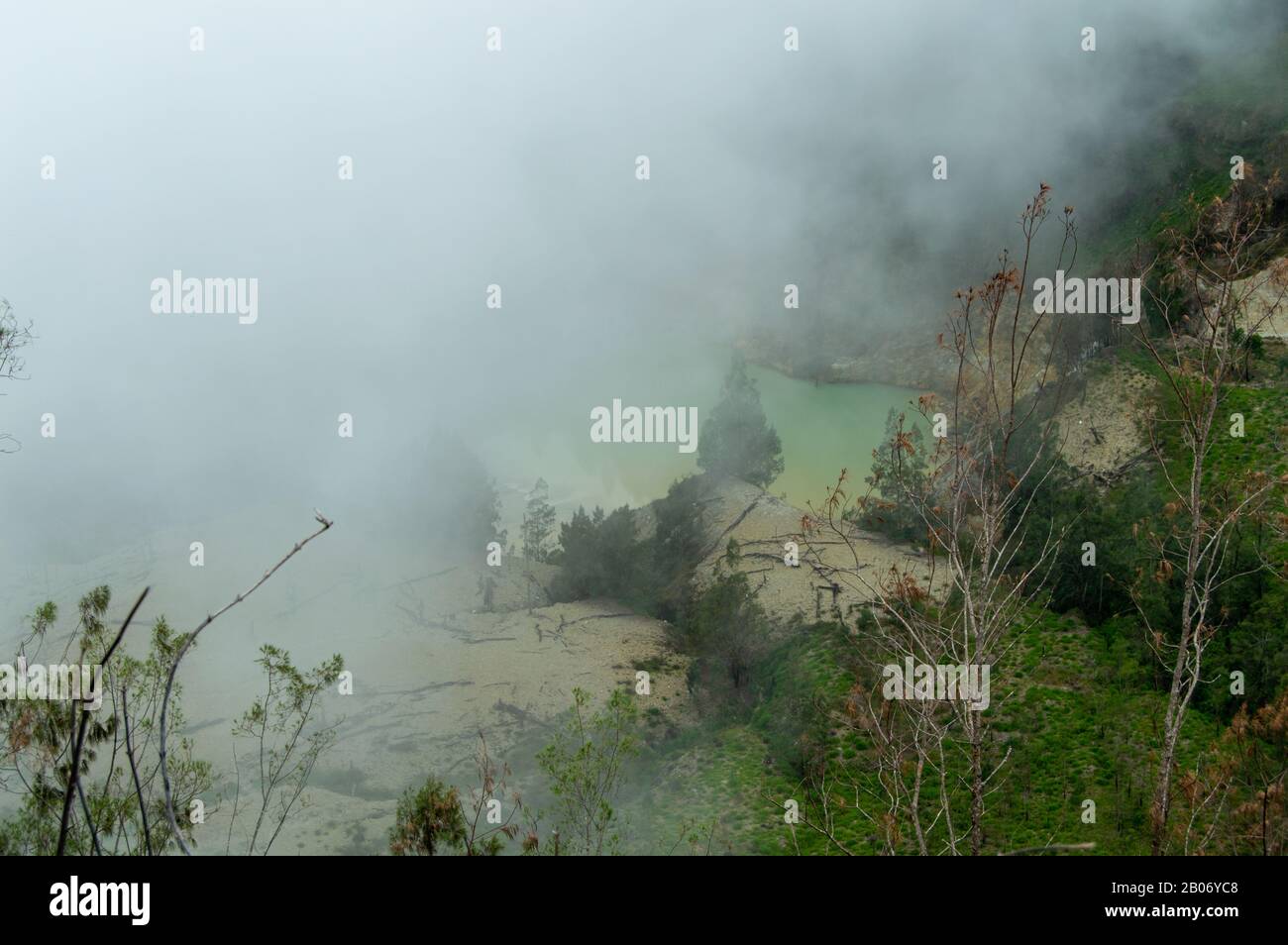 Sulphureous Crater lakes Wawo muda volcano in the white clouds in ...