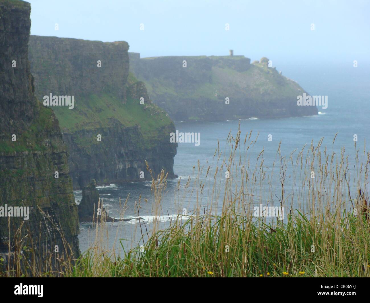 colorful ocean views, green grassy rocks, rocks and blue water. The ...
