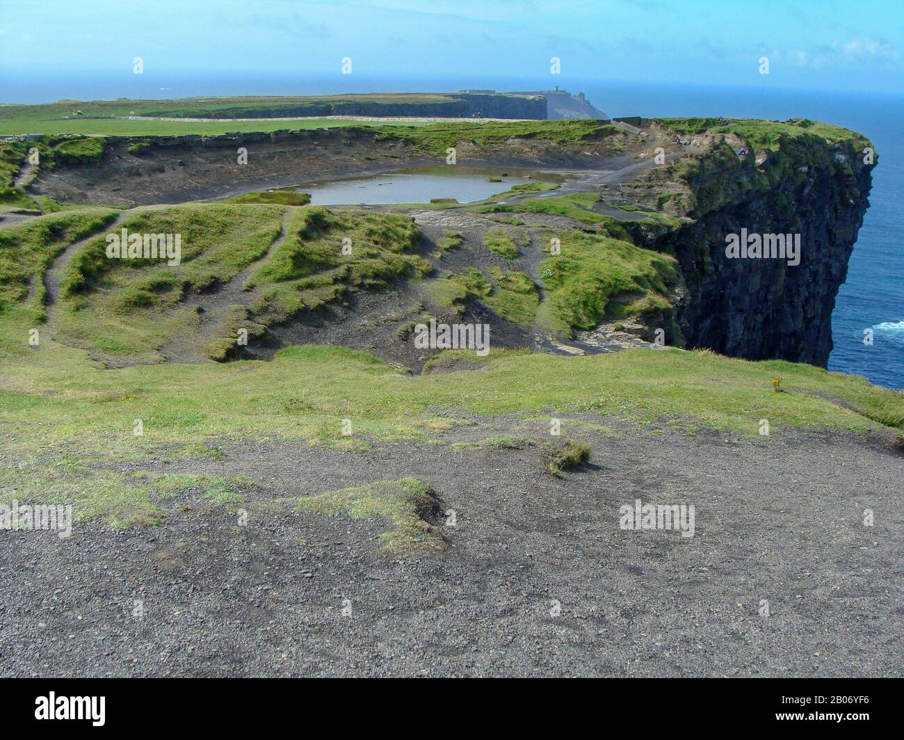 colorful ocean views, green grassy rocks, rocks and blue water. The ...