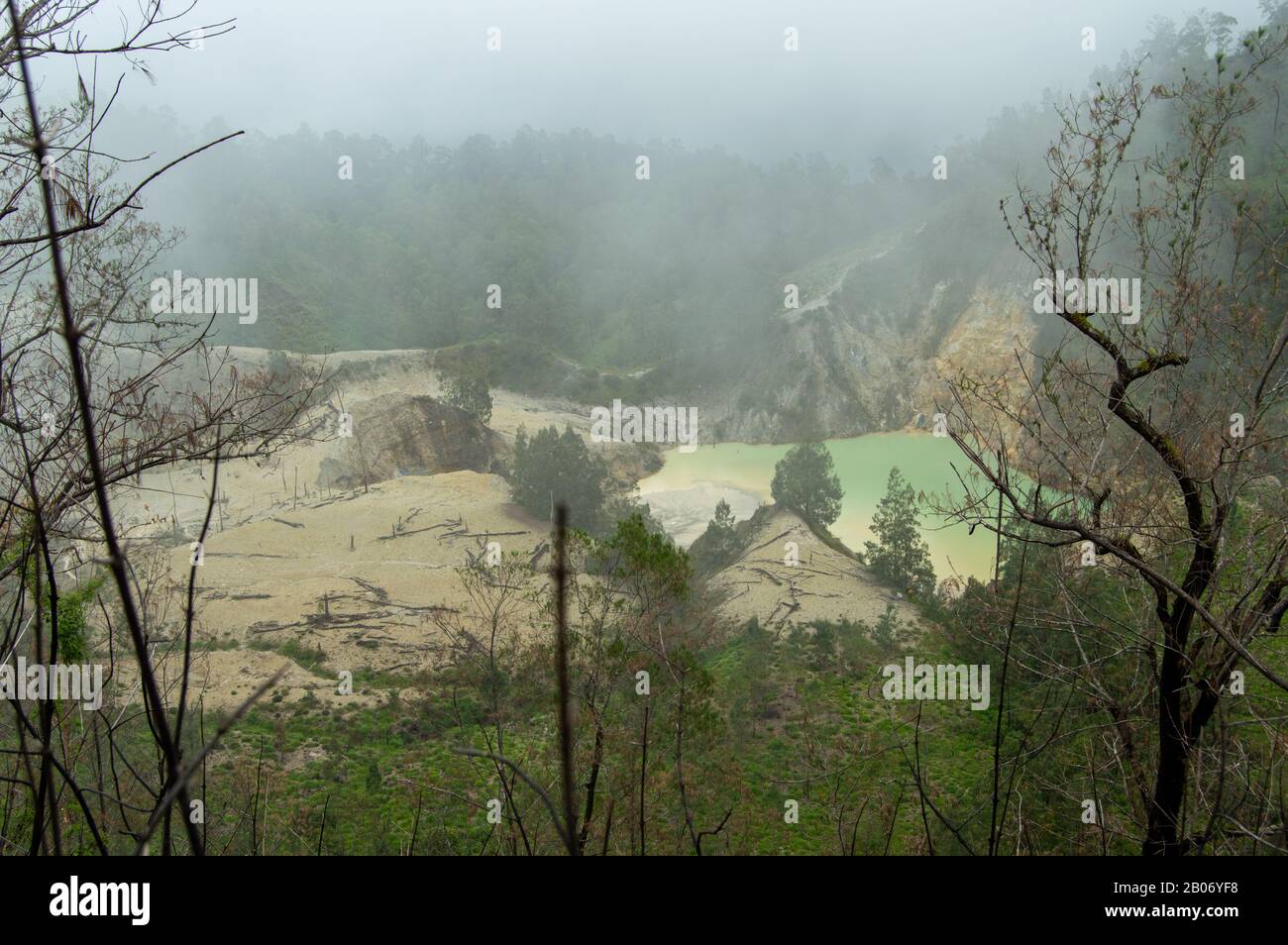 Sulphureous Crater lakes Wawo muda volcano in the white clouds in ...