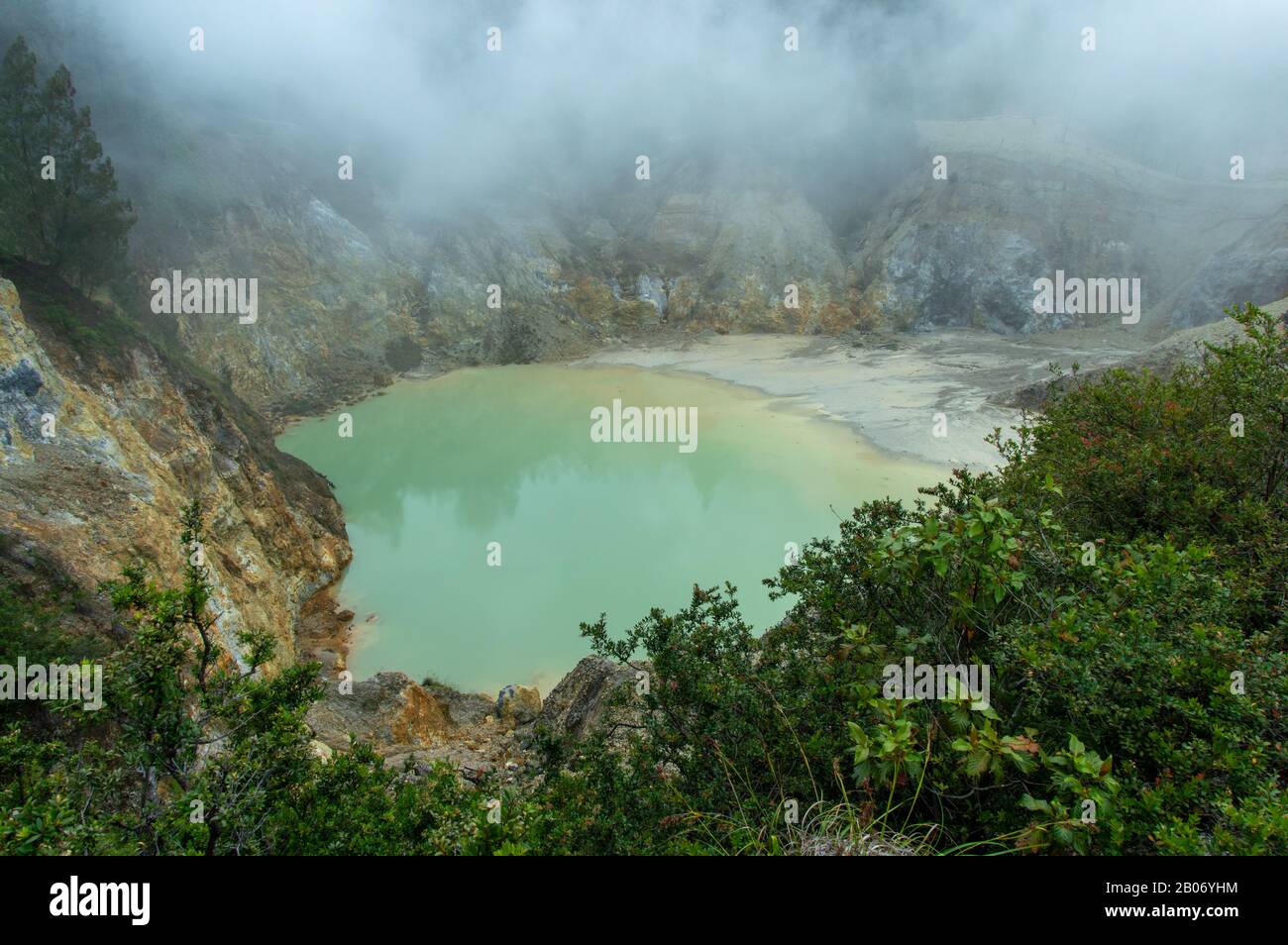 Sulphureous Crater lakes Wawo muda volcano in the white clouds in ...