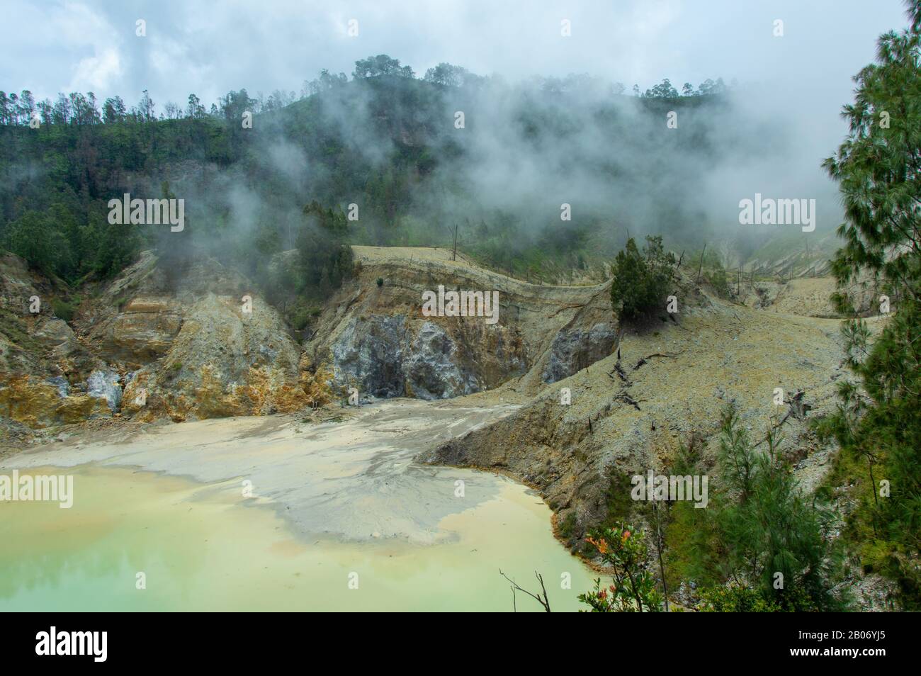 Sulphureous Crater lakes Wawo muda volcano in the white clouds in ...