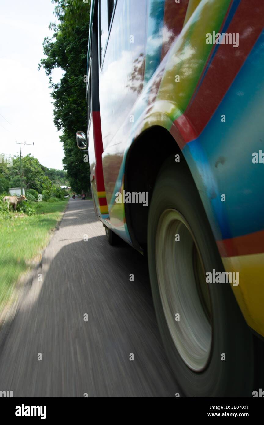 Side view of a minibus with wheel and road. Indonesia Stock Photo - Alamy