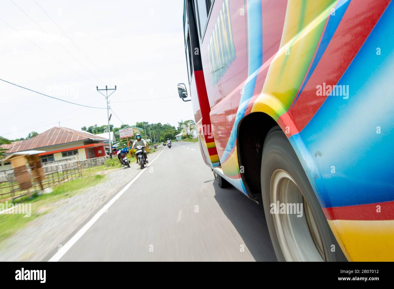 Side view of a minibus with wheel and road. Indonesia Stock Photo - Alamy
