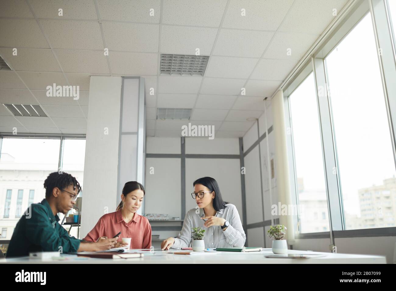 Group of business colleagues planning work together and thinking over ...
