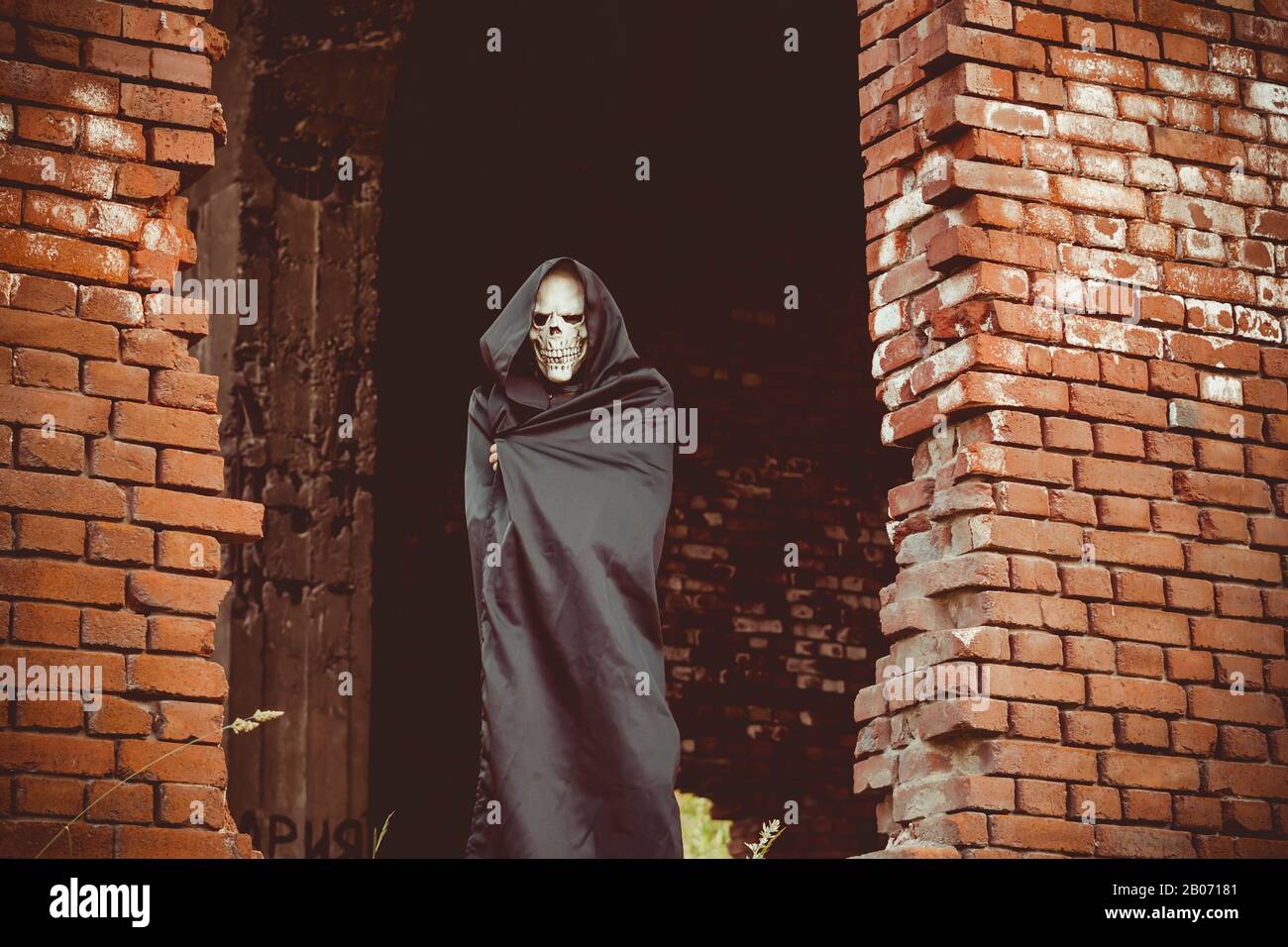 death in a black cloak in a ruined house mask skull Stock Photo - Alamy
