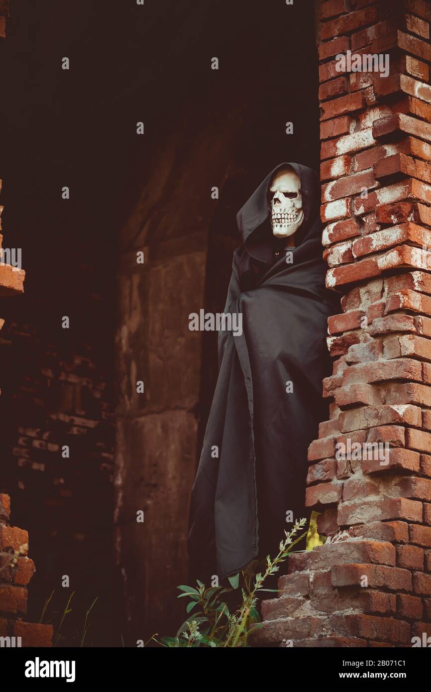 death in a black cloak in a ruined house mask skull Stock Photo - Alamy