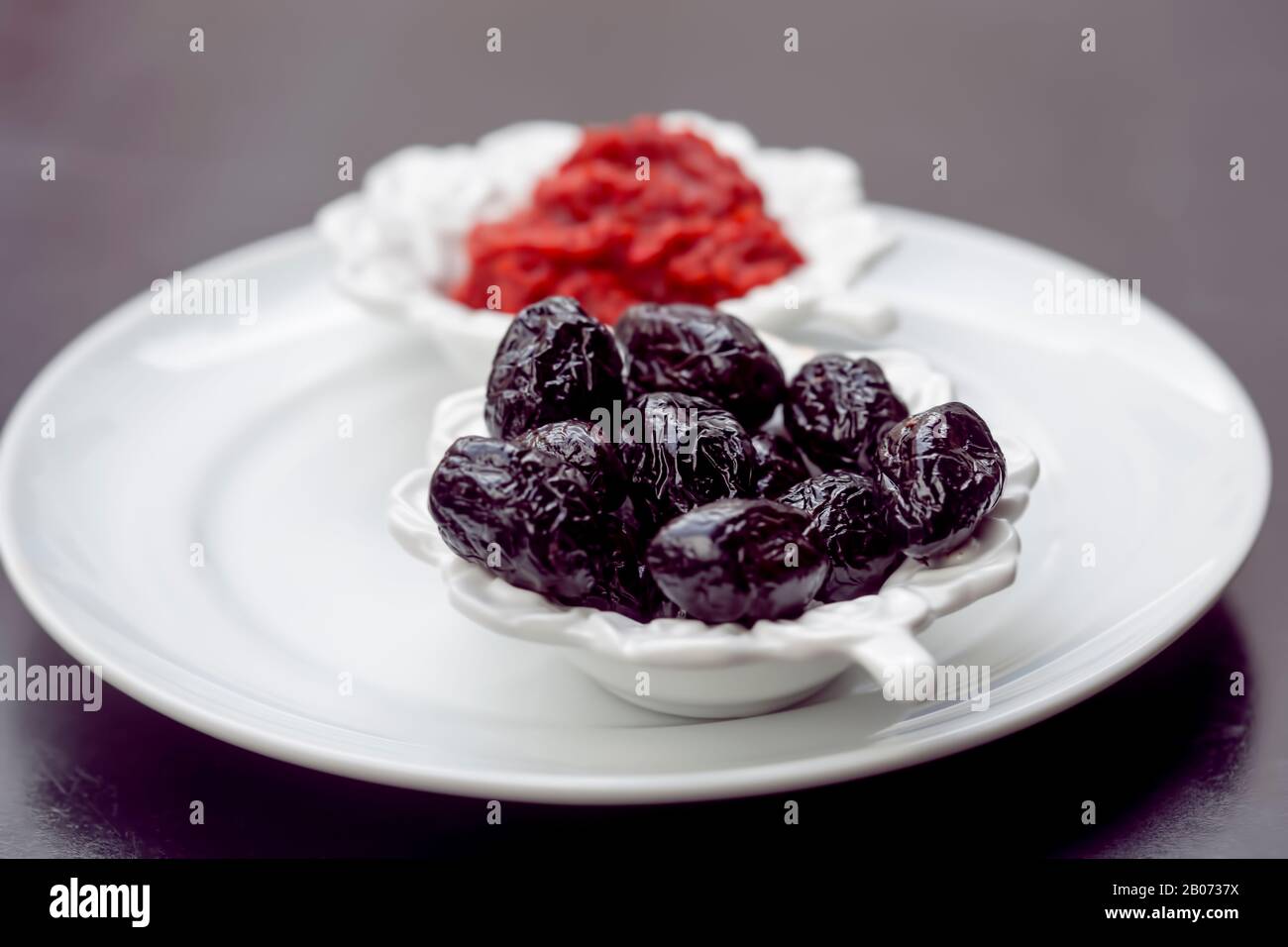 Black olives with Harissa pete antipasti Morocco Stock Photo - Alamy