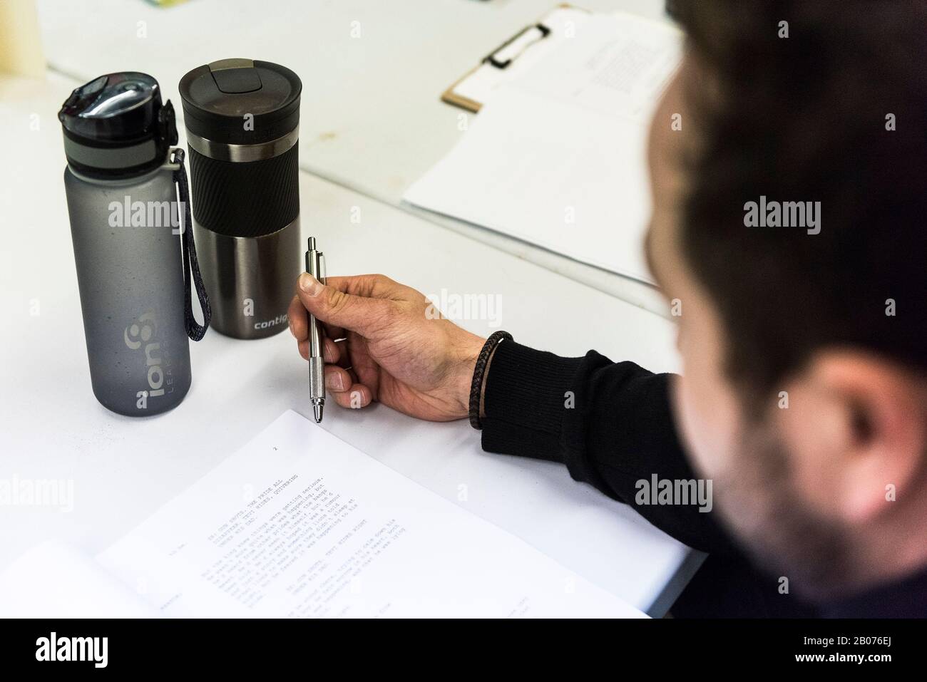 An actor in a rehearsal taking notes in the first reading of a script ...