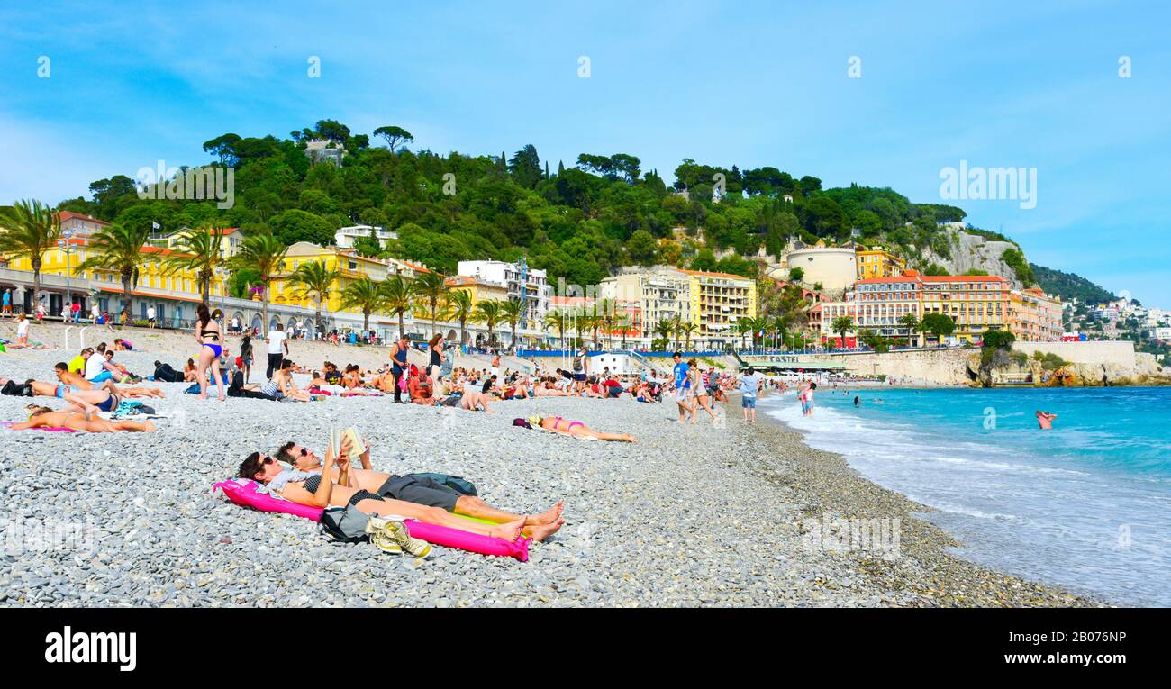 NICE, FRANCE - JUNE 4, 2017: People sunbathing on the beach in Nice, in ...