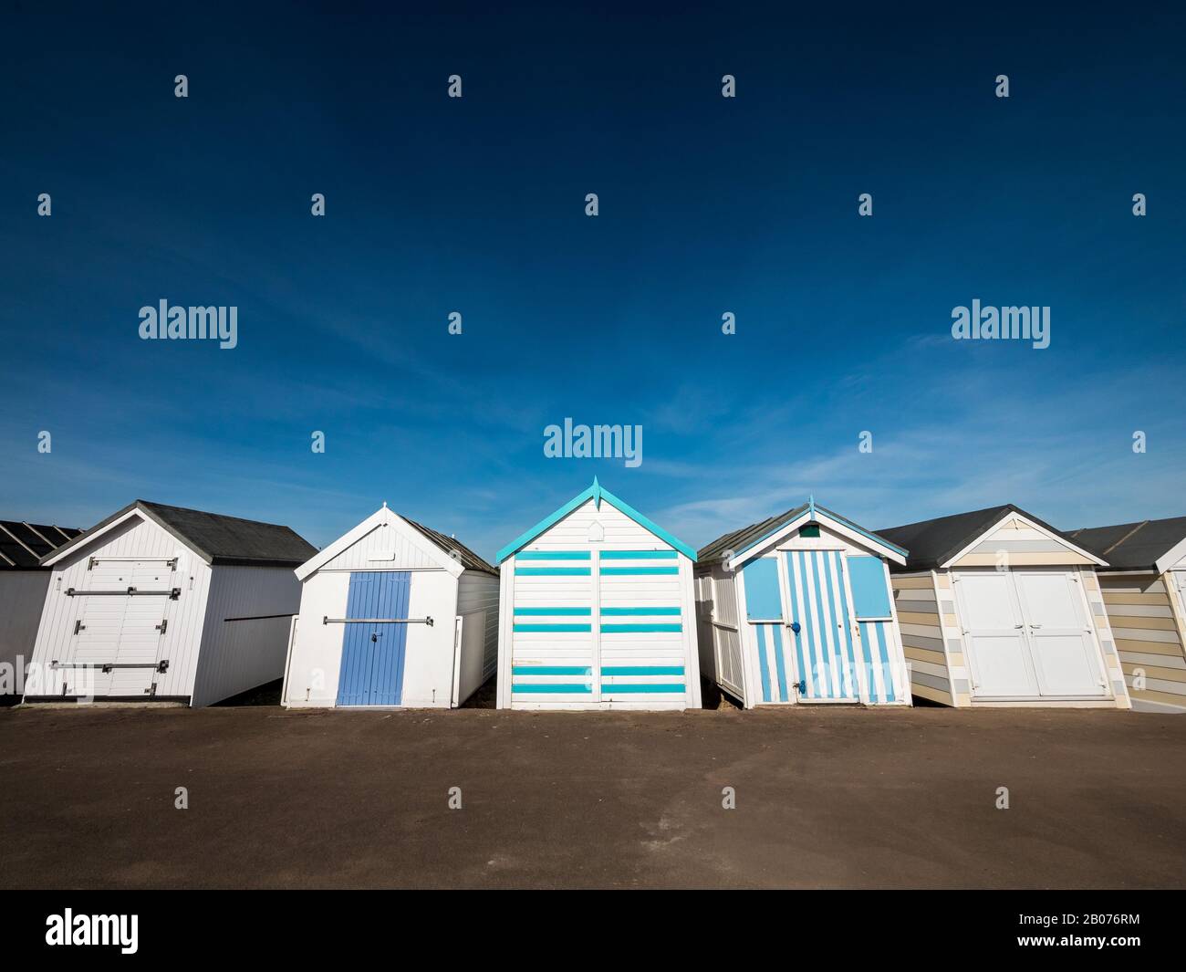 Traditional English Beach Huts. A row of beach huts commonly found in ...