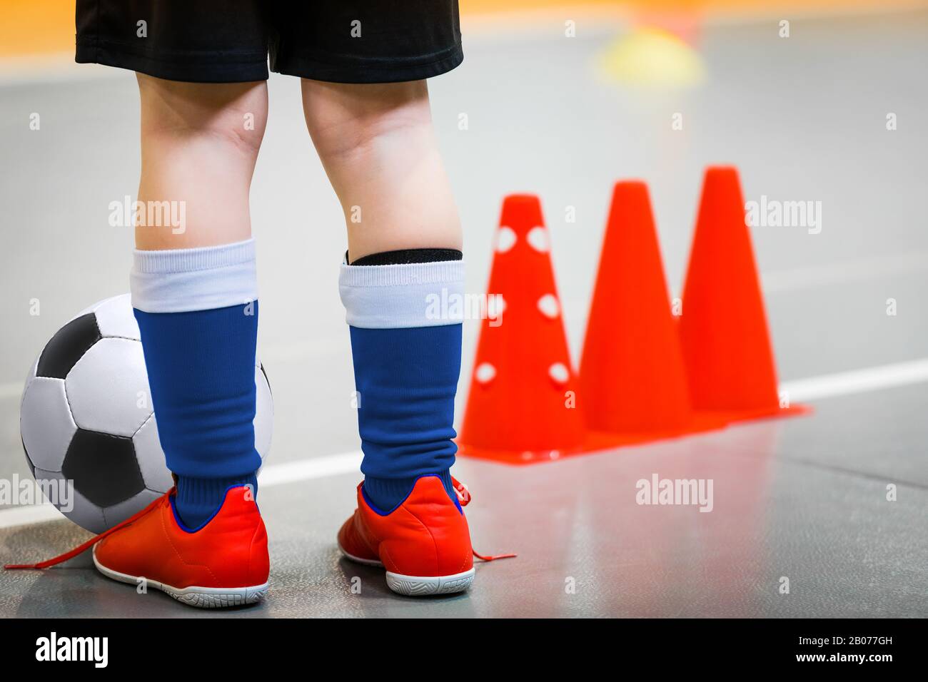 Children playing football in school gymnasium. Indoor soccer - futsal ...