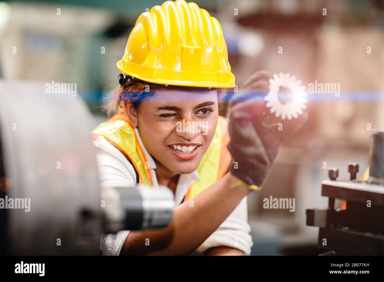 engineer worker looking at steel gear part, working precise and most ...