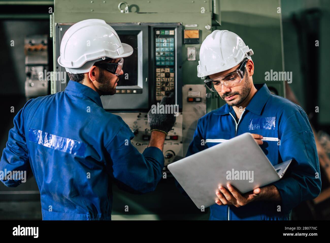 industry engineer team worker operate control heavy machine with ...