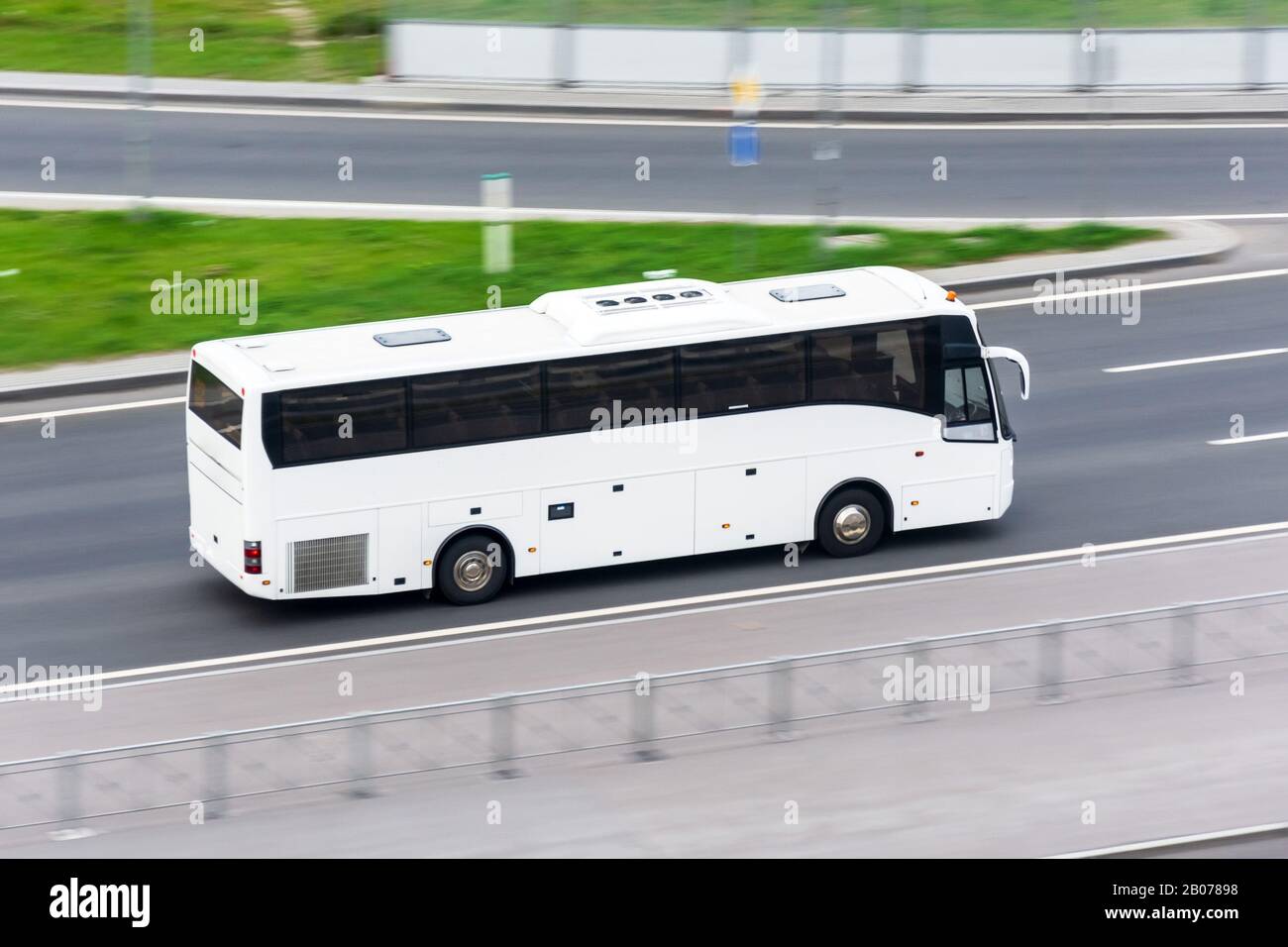 Big White Tour bus traveling on road trip Stock Photo - Alamy