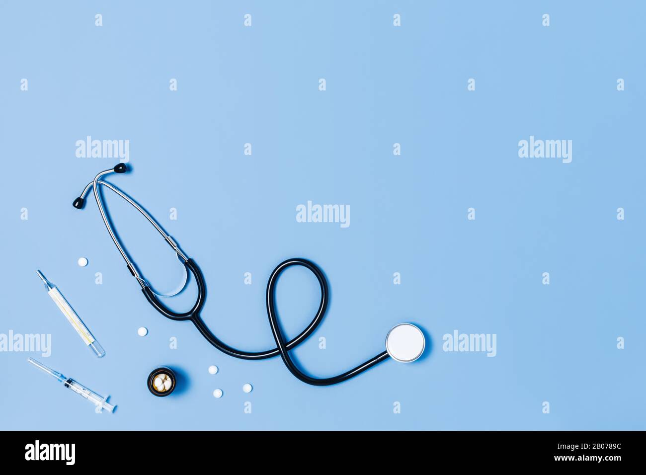 Medical blue background with stethoscope, thermometer, syringe and ...