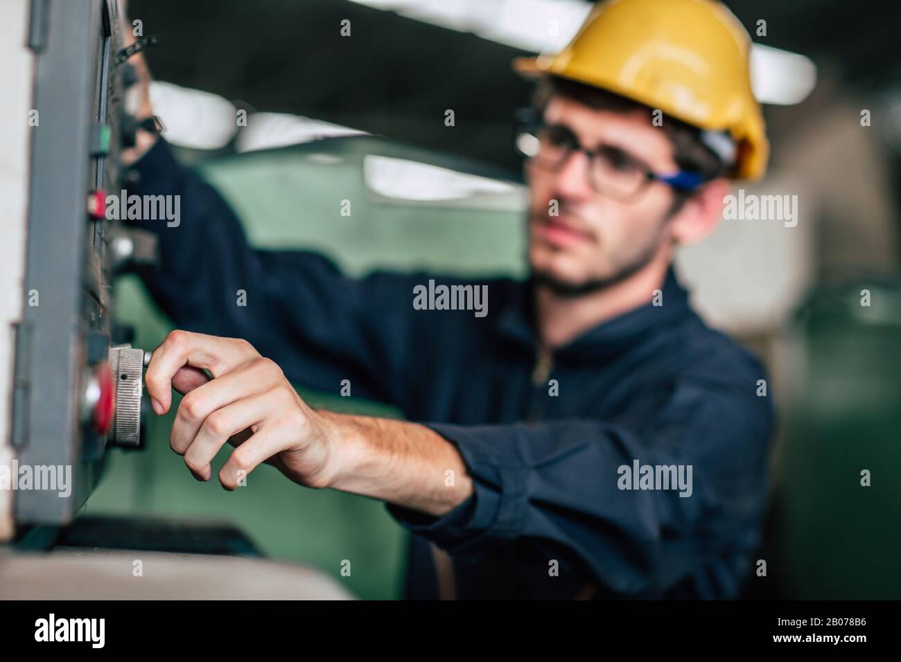 Worker operating machinery in manufacturing hi-res stock photography ...