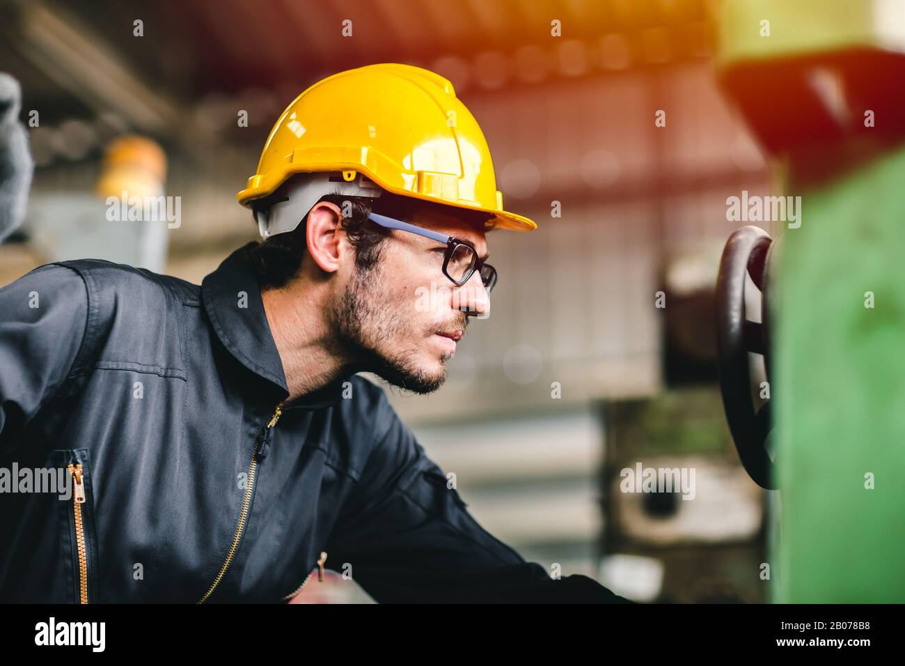 serious worker, engineer pay attention looking at the machine wear ...