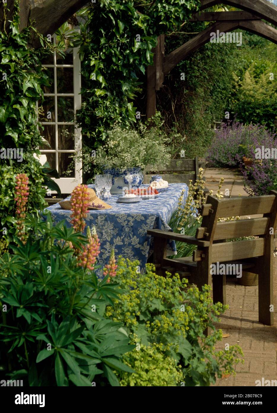 Outside eating area in summer garden Stock Photo - Alamy