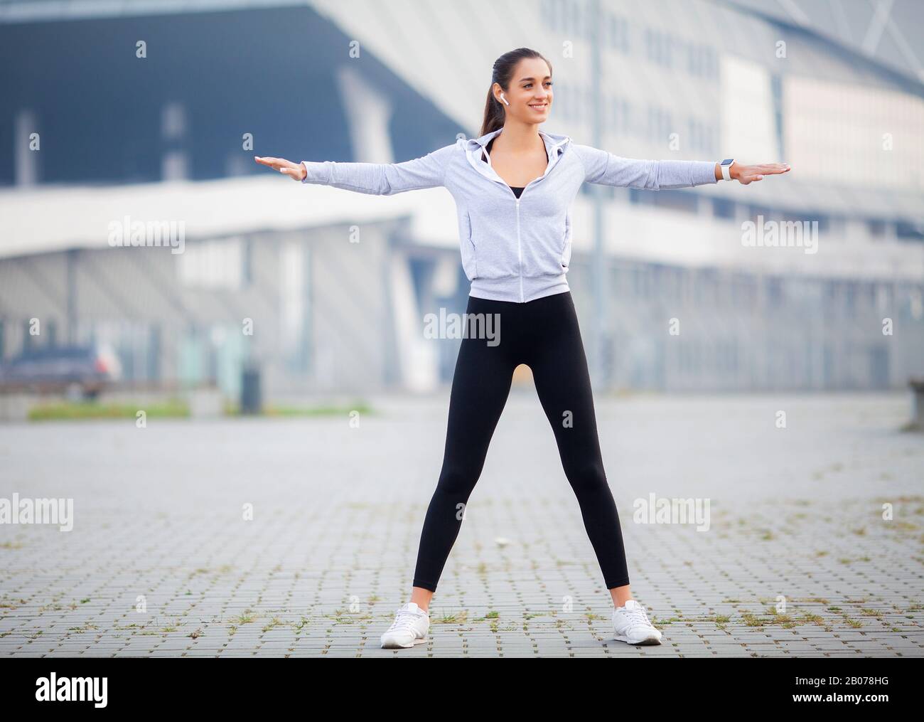 Fitness. Athletic women posing and stretching before run Stock Photo ...