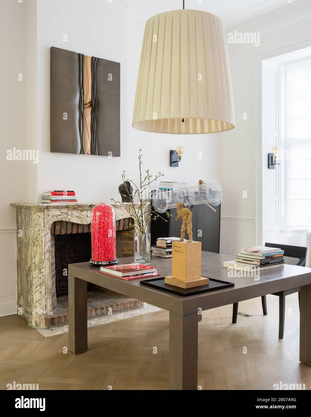 Sculpture on table under pendant light Stock Photo - Alamy