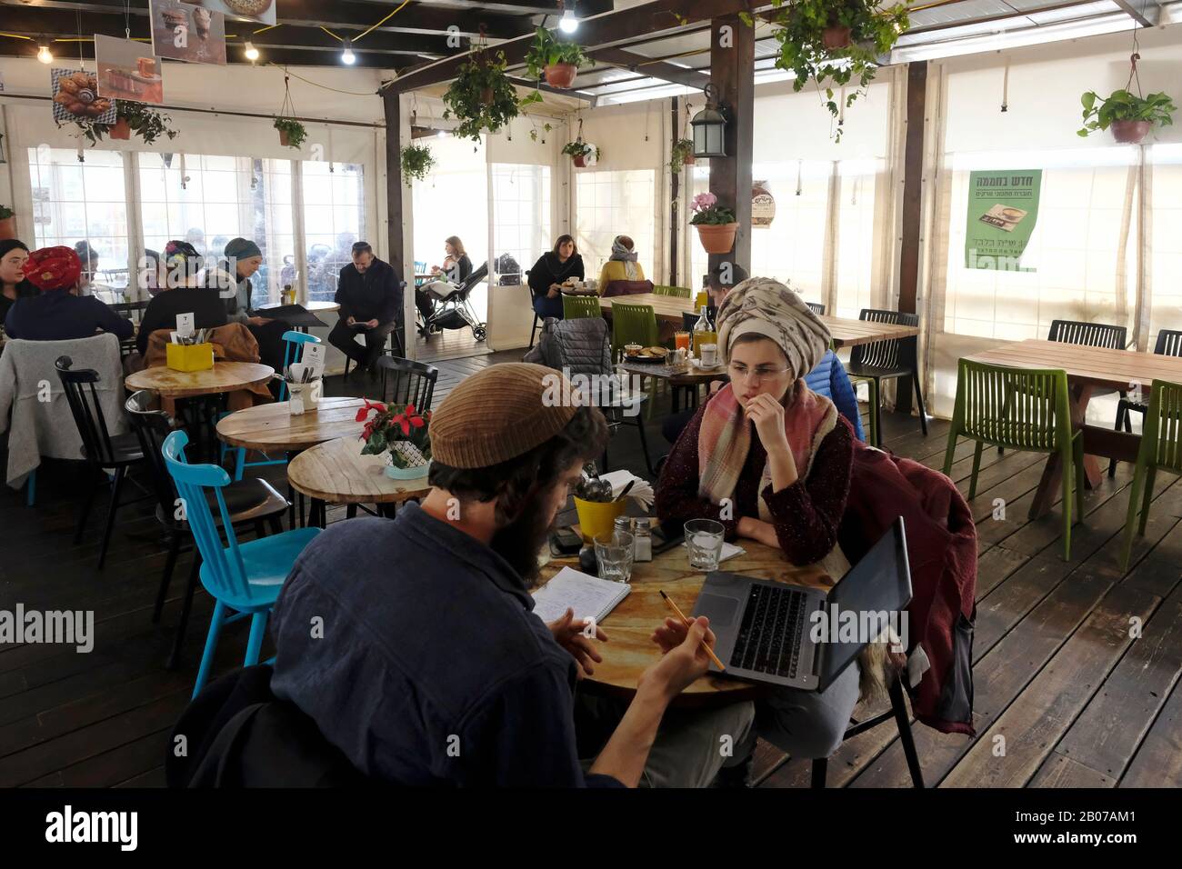 Jewish settlers sit in Hahamama cafe at the entrance to Kibbutz Kfar ...