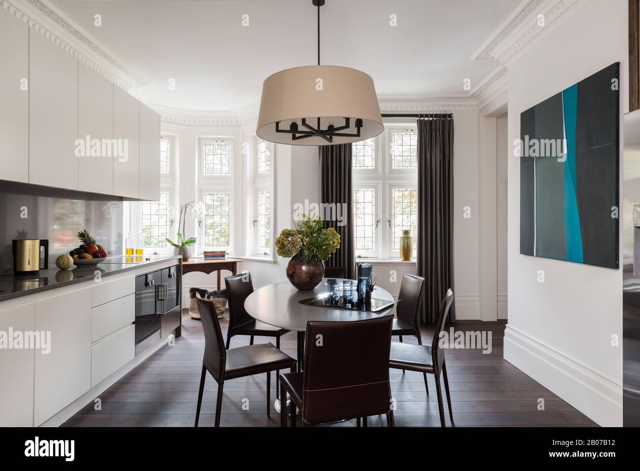 Dining table in modern kitchen Stock Photo - Alamy