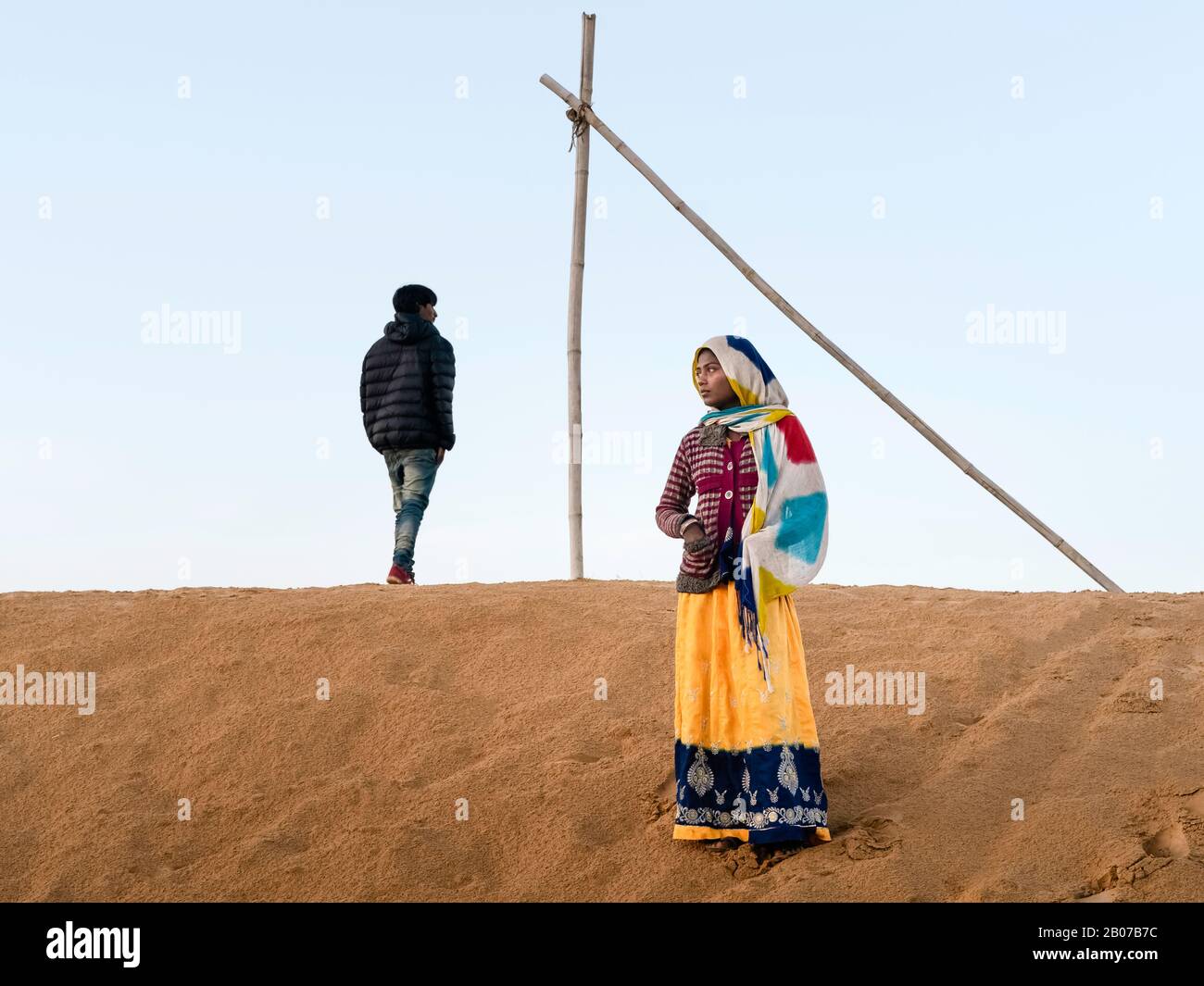 Young gypsy woman in traditional colorful clothes and smiling walking ...