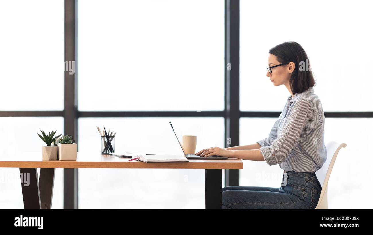 Confident woman using personal computer at home Stock Photo - Alamy