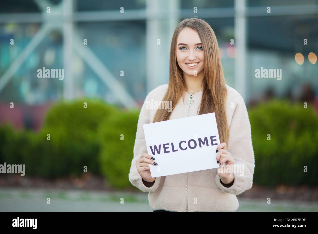 Women business with the poster with welcome message Stock Photo - Alamy