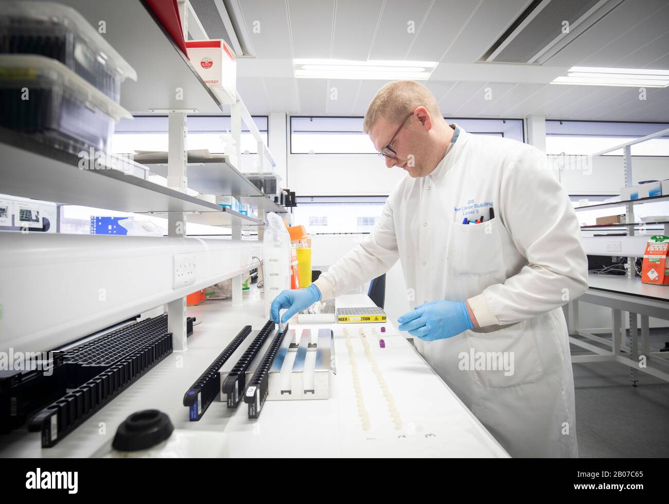 Clinical support technician Douglas Condie extracts viruses from swab ...