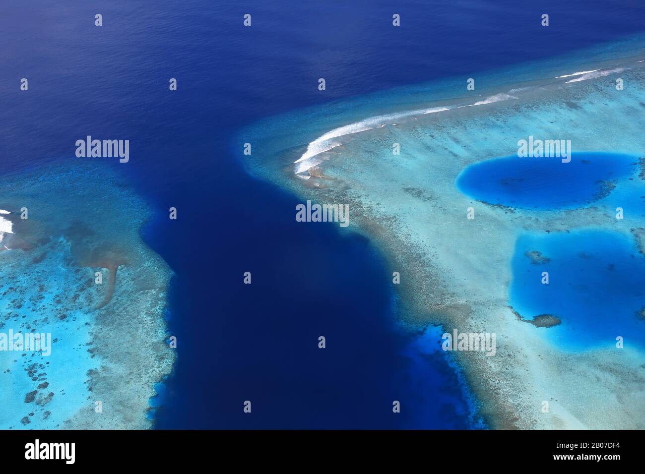 Aerial view of channel trough the coral reef in the atoll of the ...