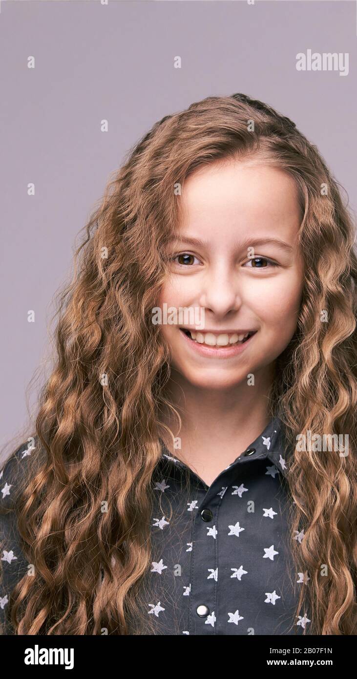 Prety little smile woman. Curly long hair. Nice young girl studio ...