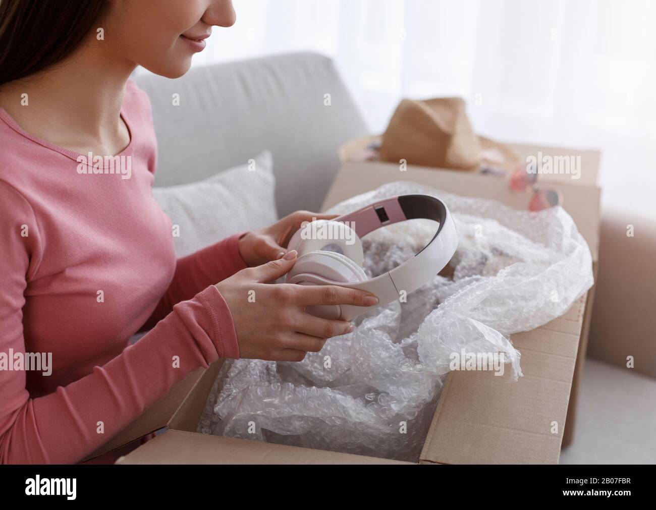 Caucasian woman receiving unpacking package hi-res stock photography ...