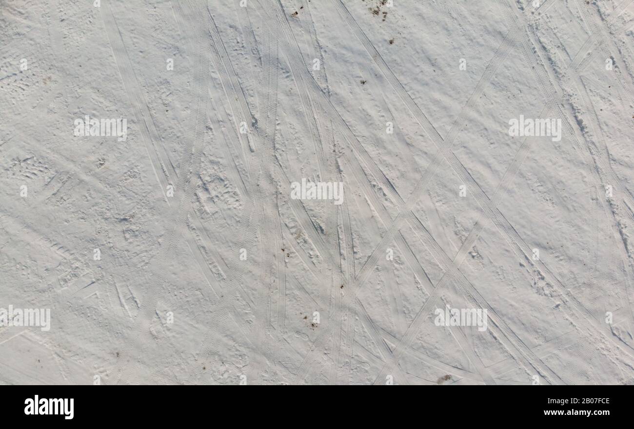 Top down view of snow ground crisscrossed with Tyre Track Stock Photo ...