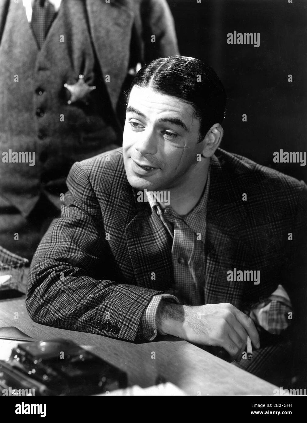 PAUL MUNI as Tony Camonte and C. HENRY GORDON (partially obscured) in ...