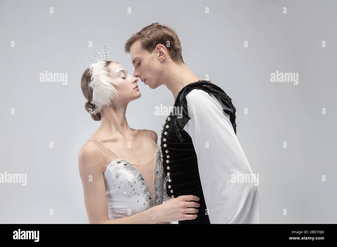 Grey. Graceful classic ballet dancers dancing isolated on white studio ...
