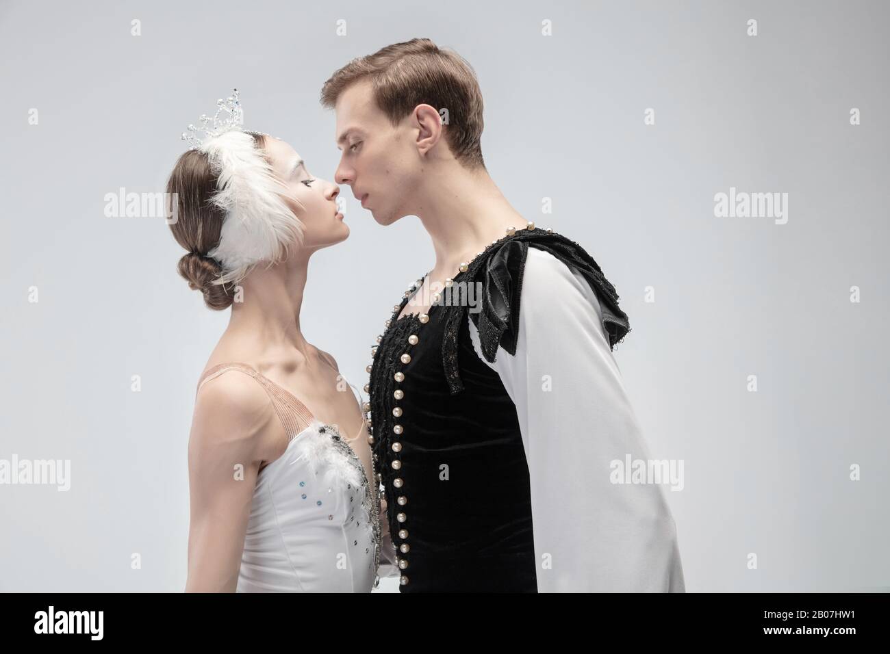 Warm. Graceful classic ballet dancers dancing isolated on white studio ...