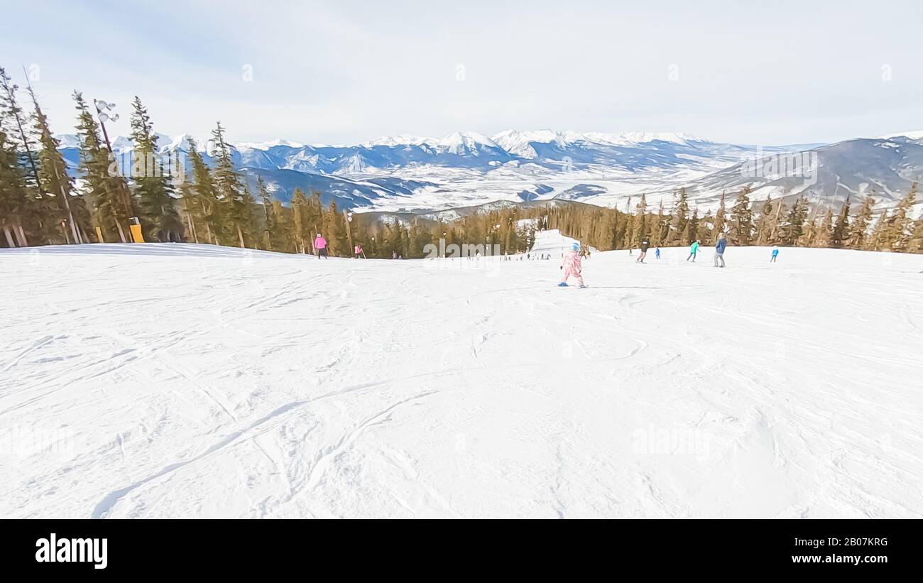 Little girl learning how to ski down the hill on alpine mountains Stock ...