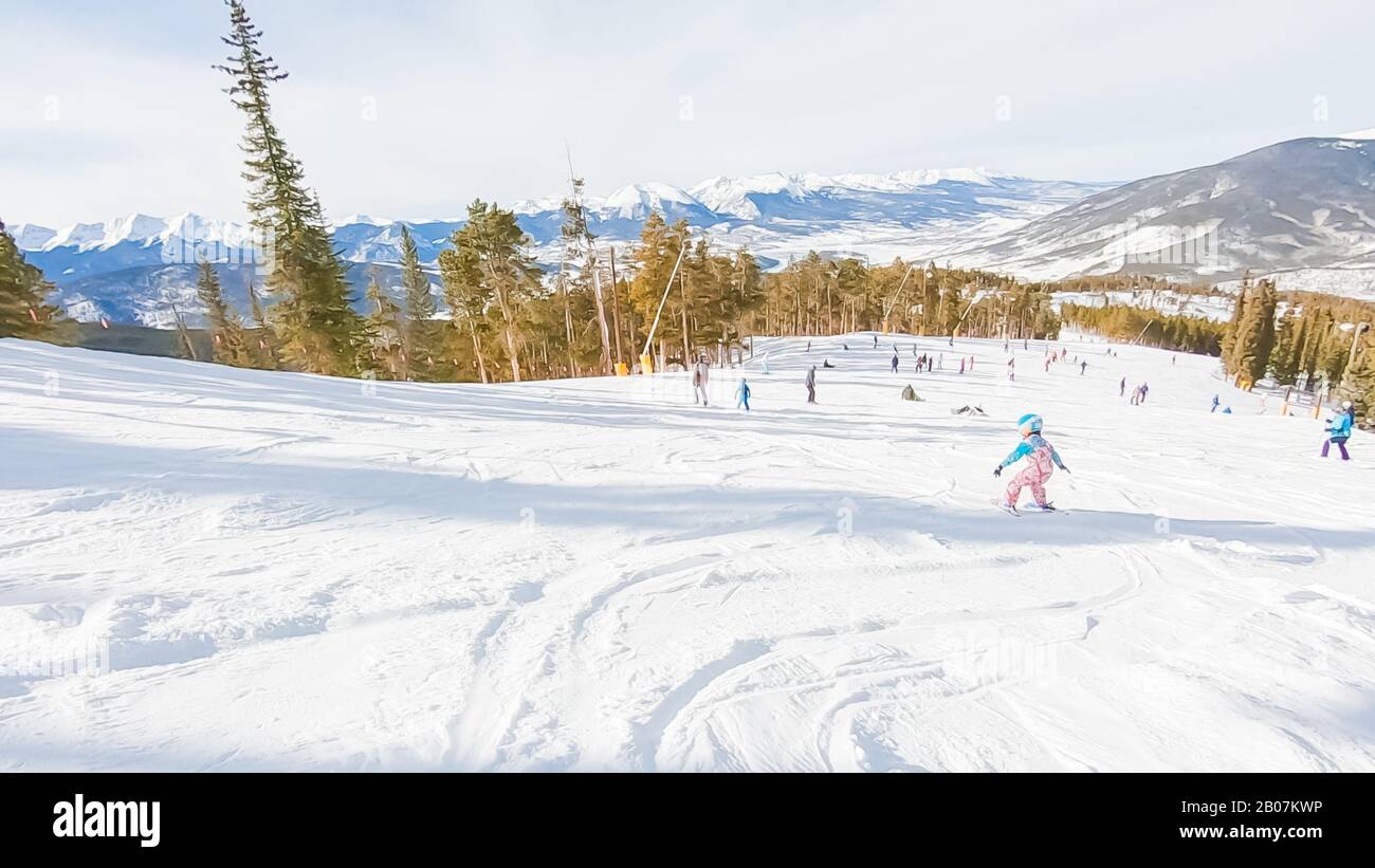 Little girl learning how to ski down the hill on alpine mountains Stock ...