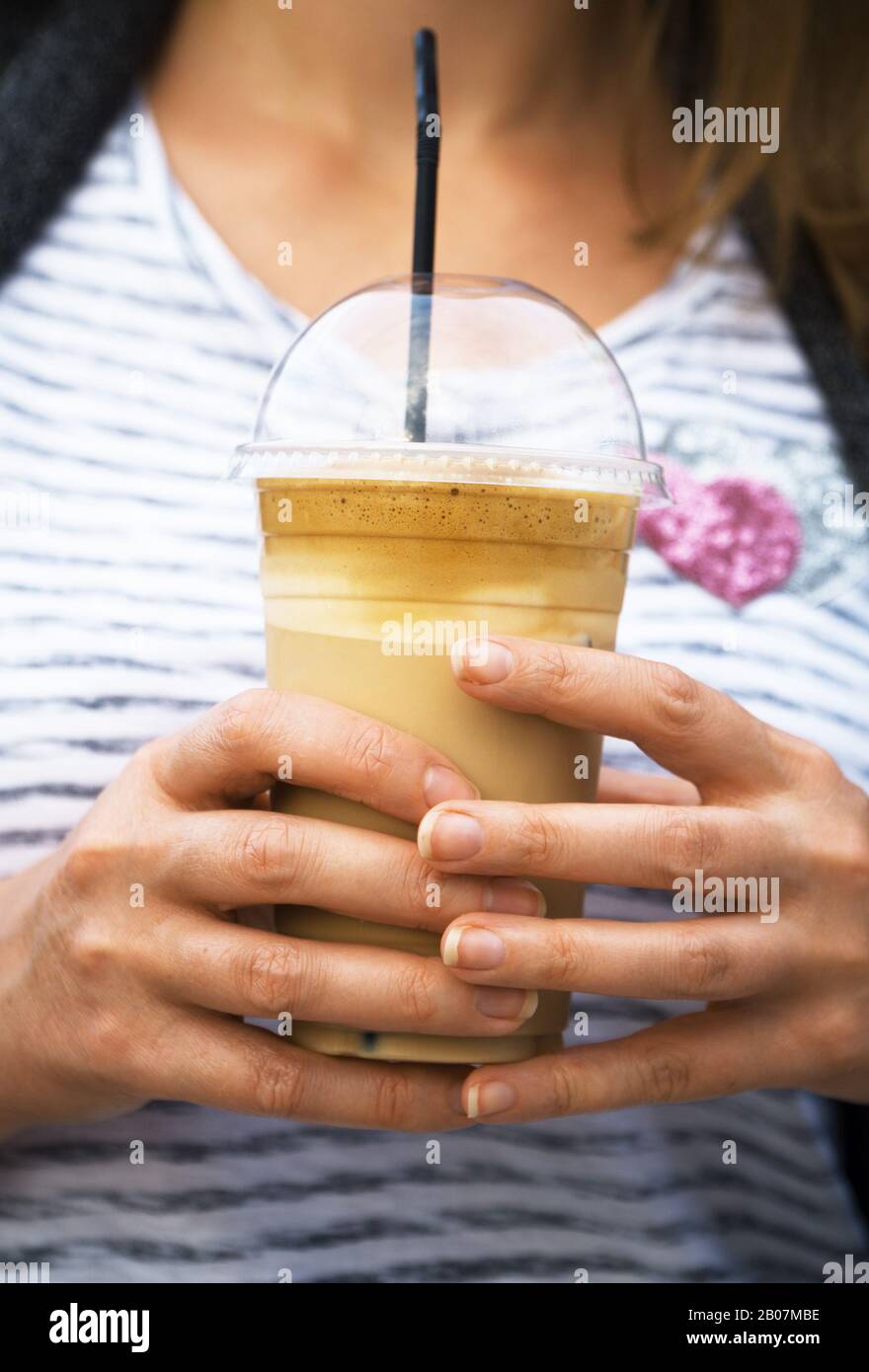 Woman's hand holding cold Frappe Coffee Stock Photo - Alamy