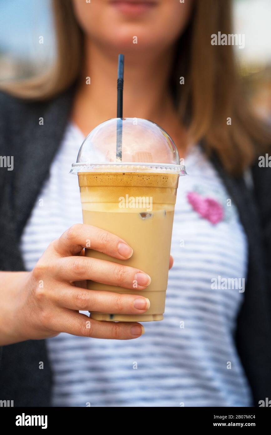 Woman's hand holding cold Frappe Coffee Stock Photo - Alamy